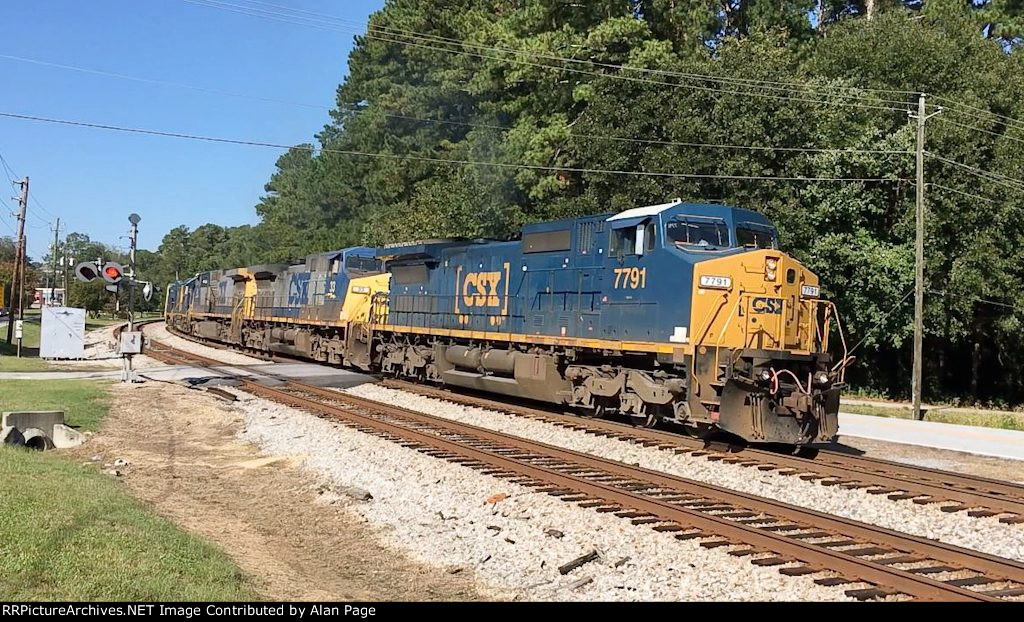 CSX 7791 leads AC44CWs 33, and 94, and GP40-2 6472 and mate 2324 with SB mixed freight past ...